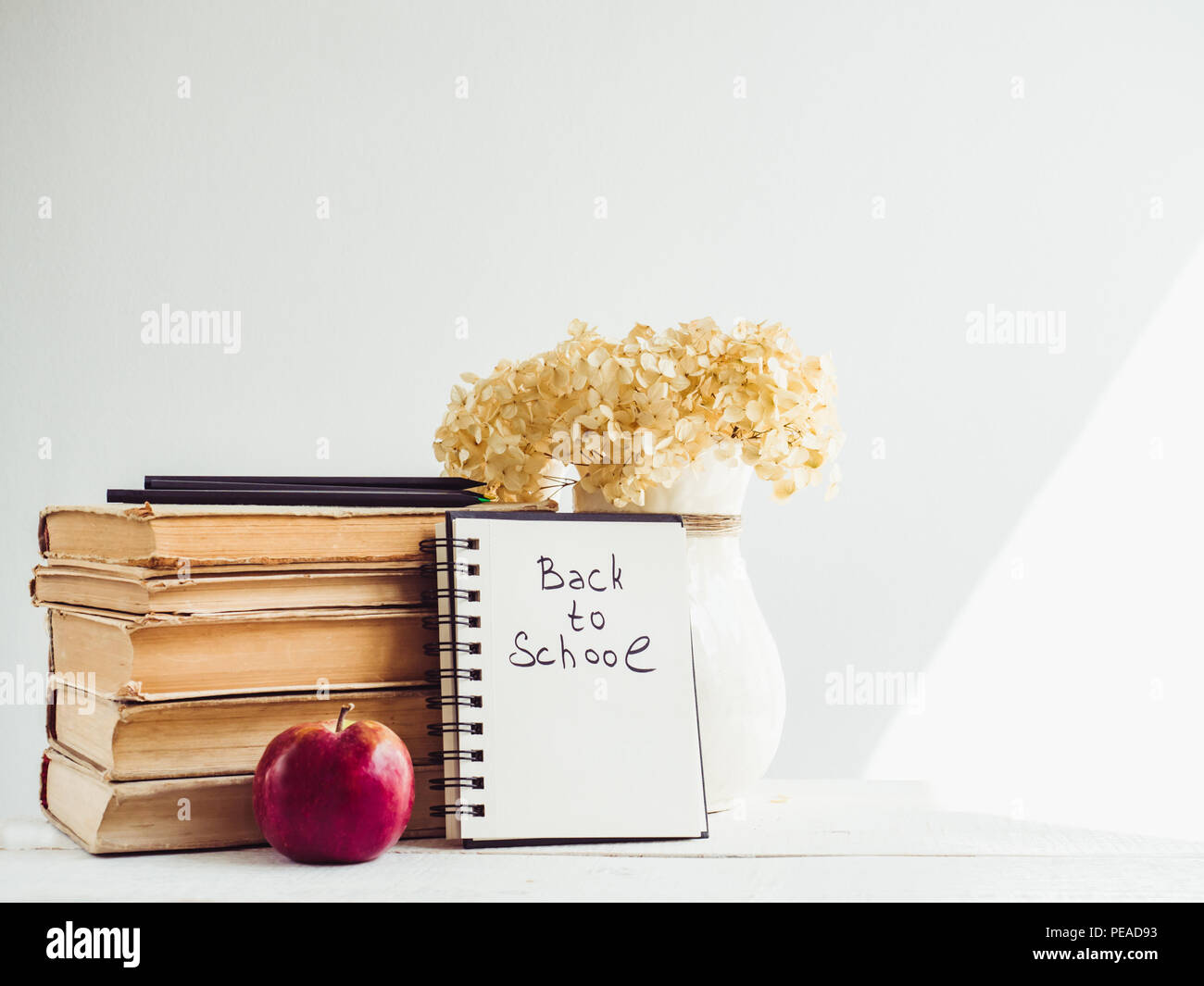 Vintage books, pencils, notepad with a handwritten inscription and an ...