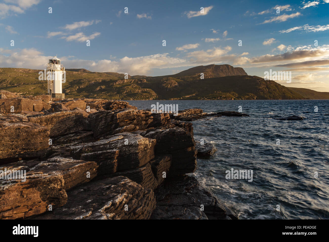 Rhue Lighthouse, Ullapool, Scotland, at sunset in summer Stock Photo ...
