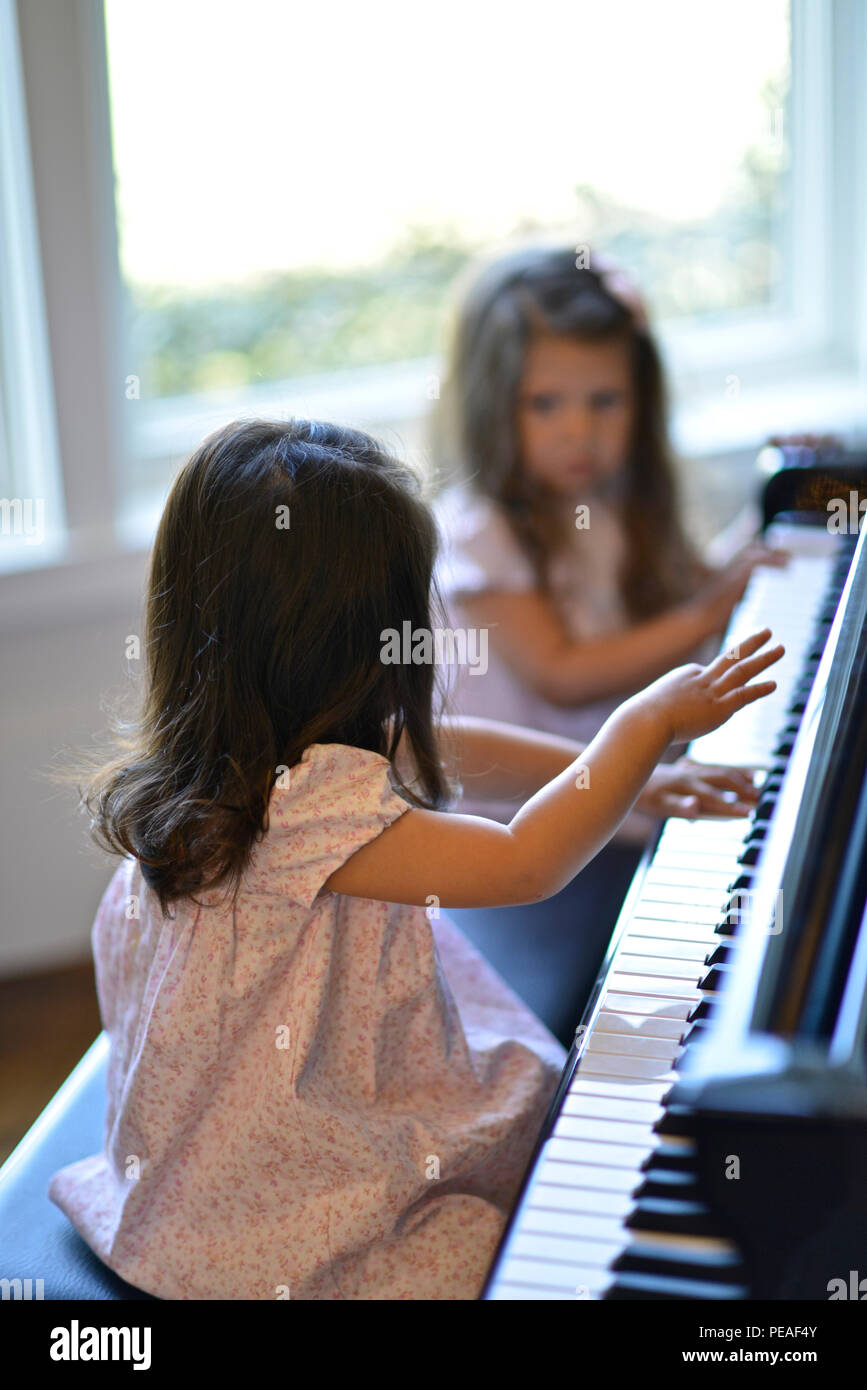 Two Girls Playing Piano High Resolution Stock Photography and Images ...