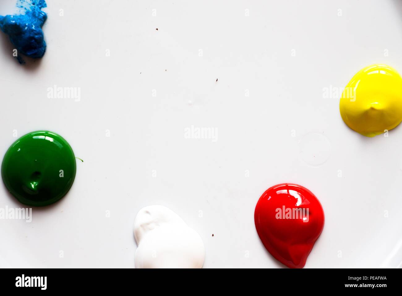 Small drops of paint lie on a white surface. This paint is ready for ...