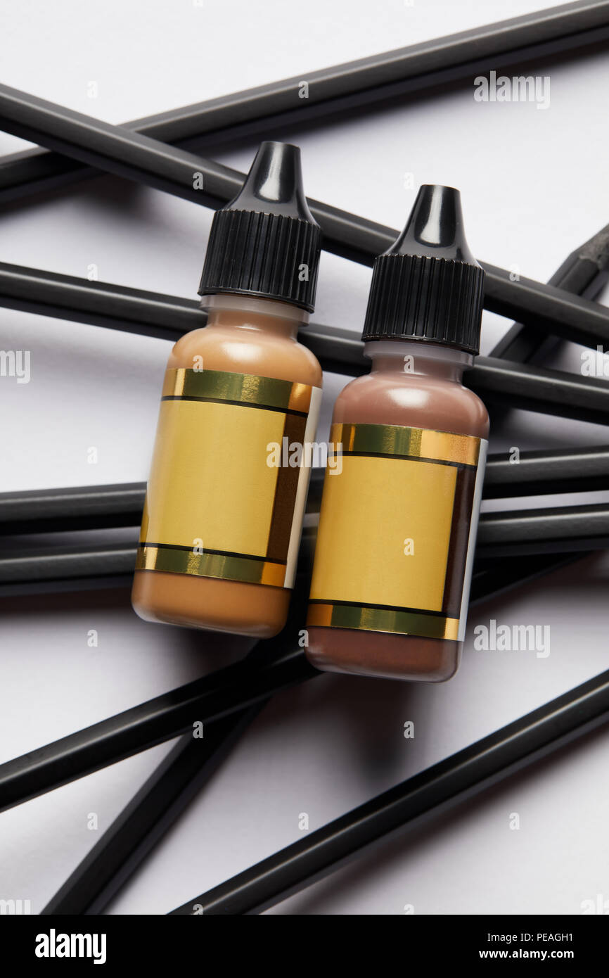 close-up view of cosmetic bottles with blank labels and tools for ...