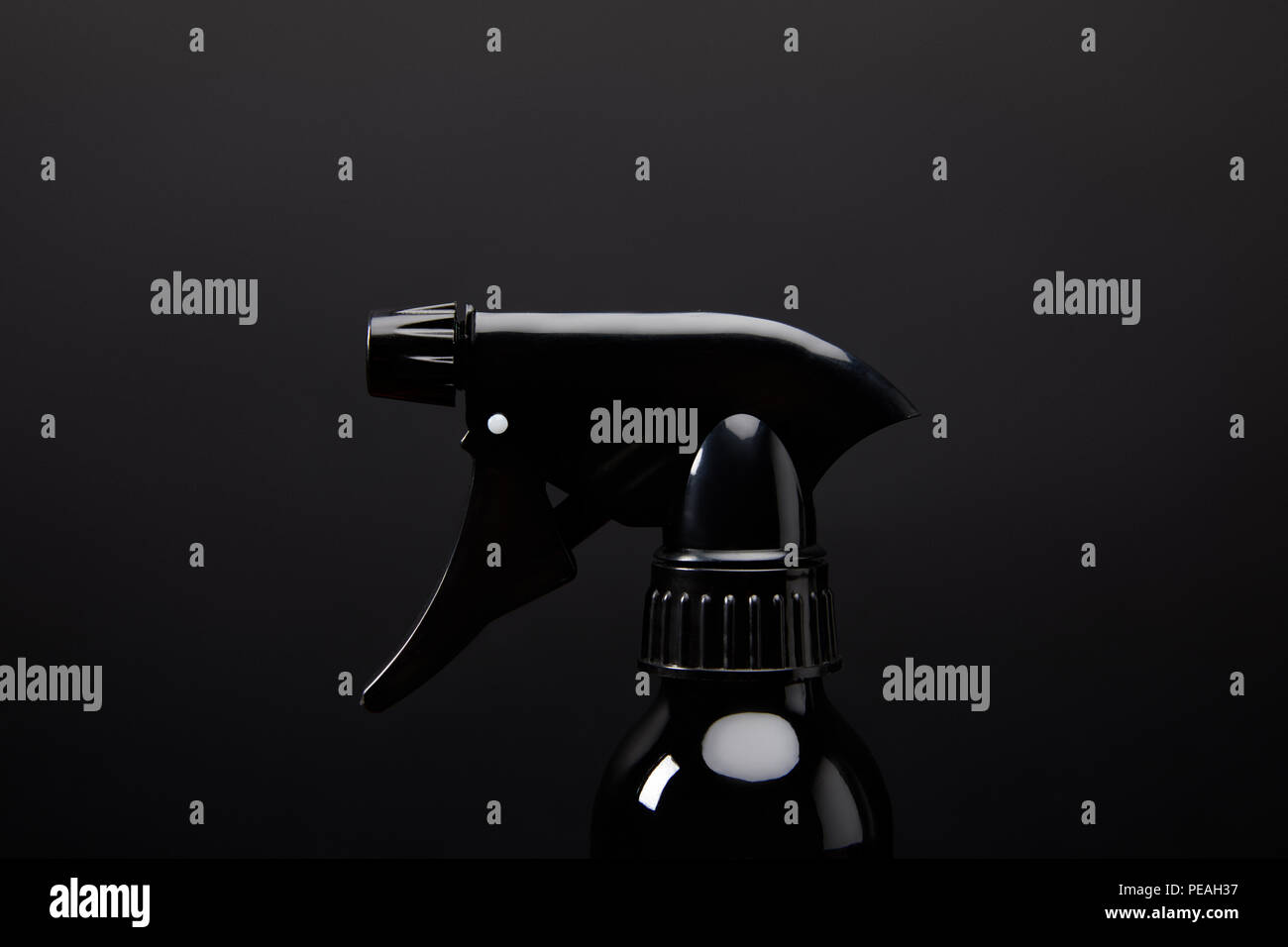 close up view of black spray bottle on black wall background Stock ...