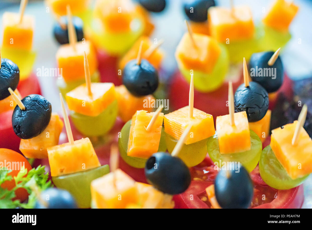 Appetizer of cheese cubes, grapes and tomato Stock Photo - Alamy