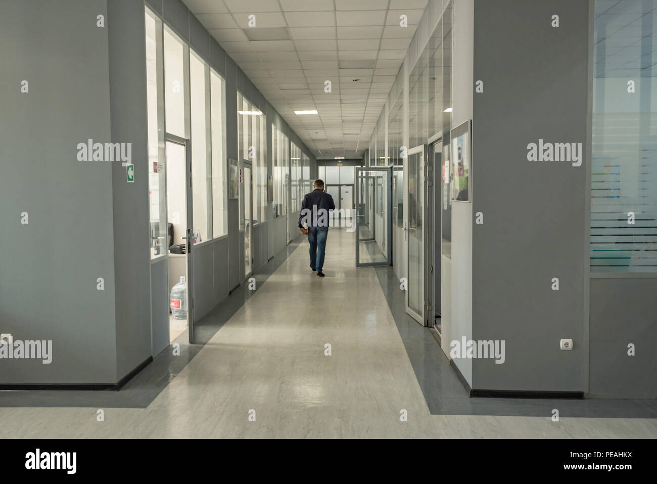 Man in corridor in the modern office building Stock Photo - Alamy