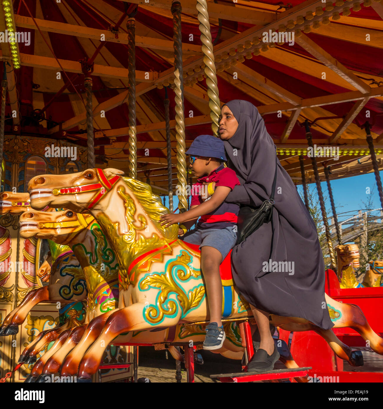 Child riding carousel hi-res stock photography and images - Alamy
