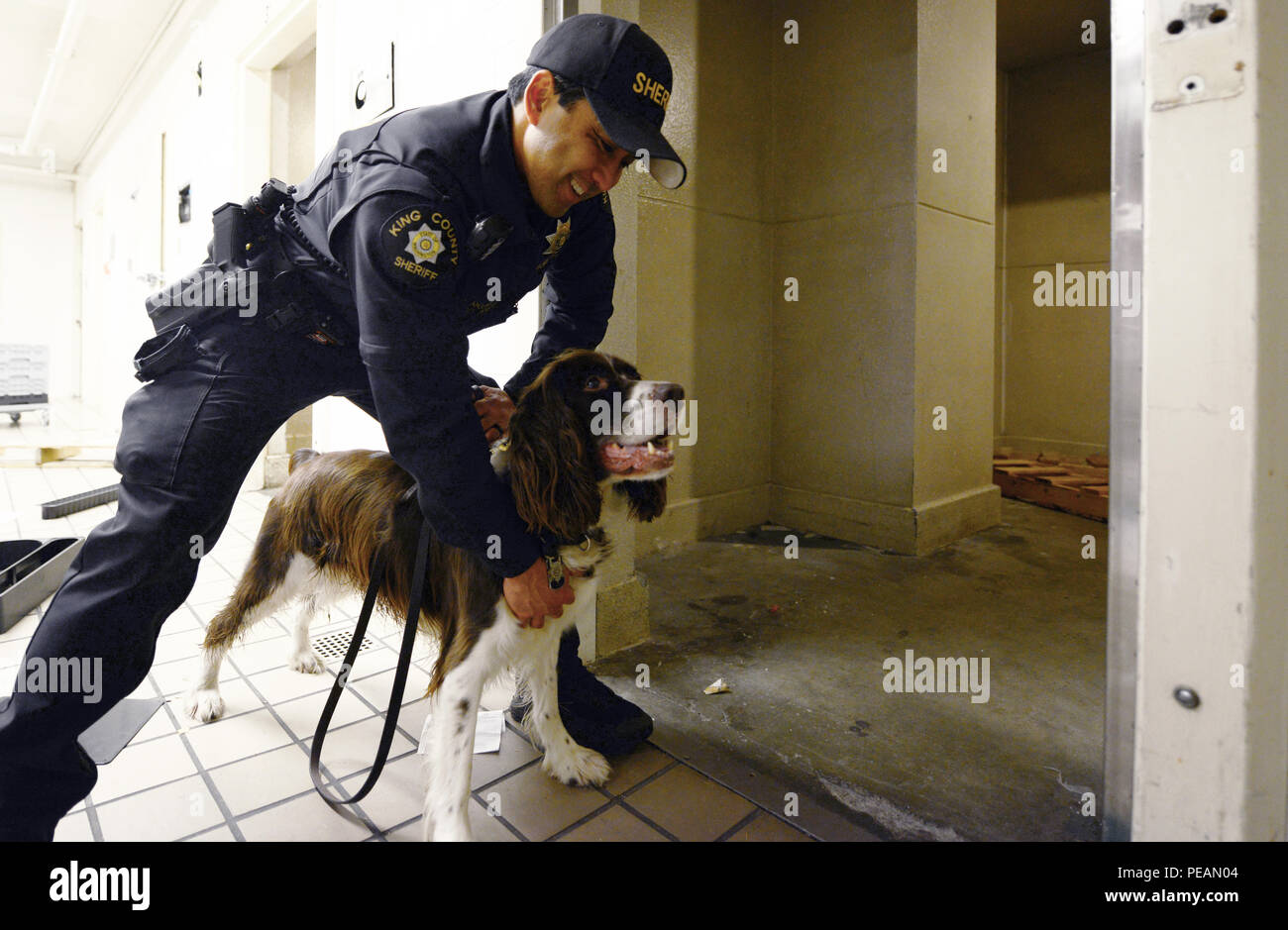 Deputy Jon Akiona of King County Sheriffs Office pets his parter, Chase ...