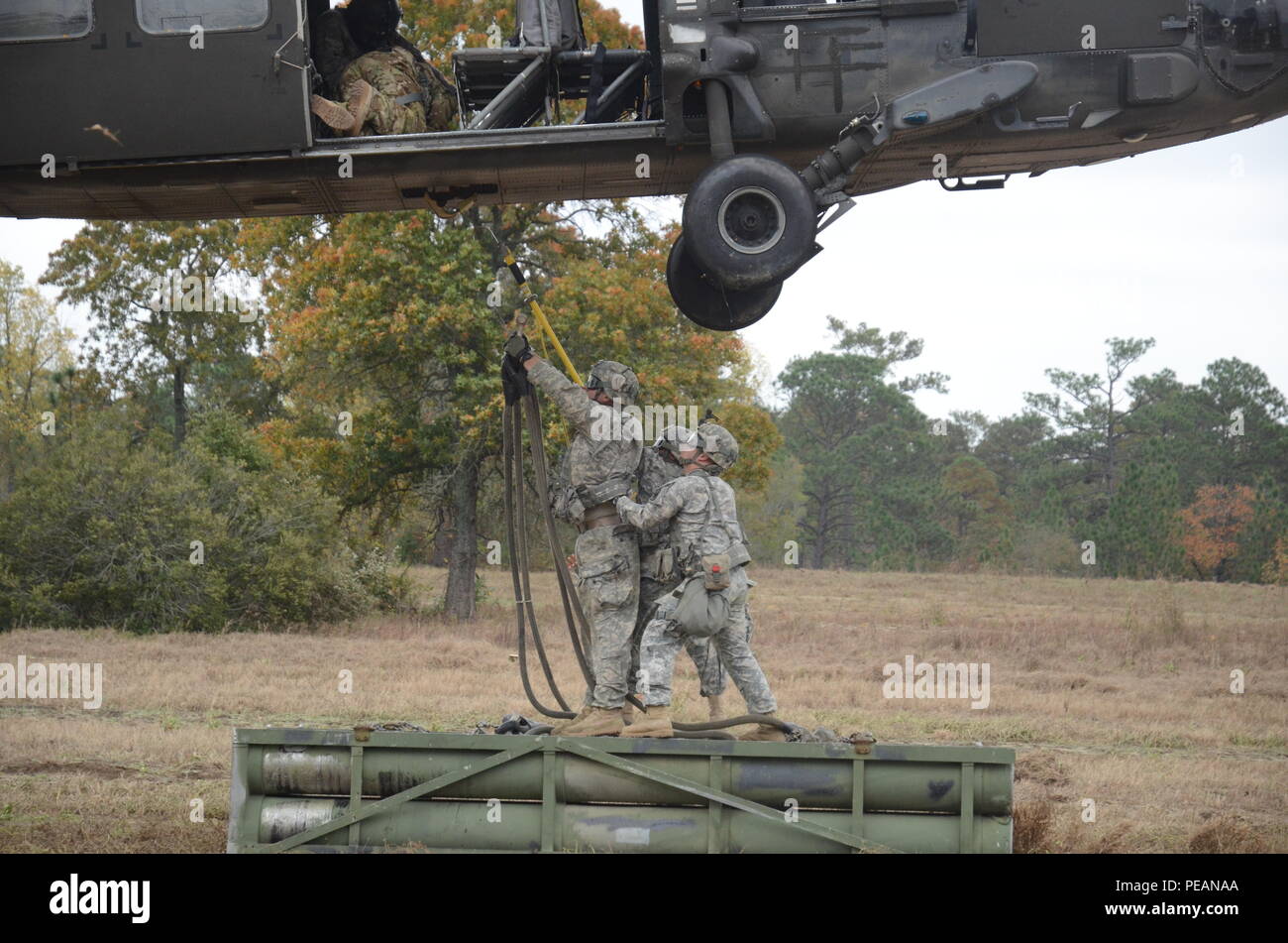 Soldiers from the 188th BSB hook up a HIMARs ammunition pod to a Black ...