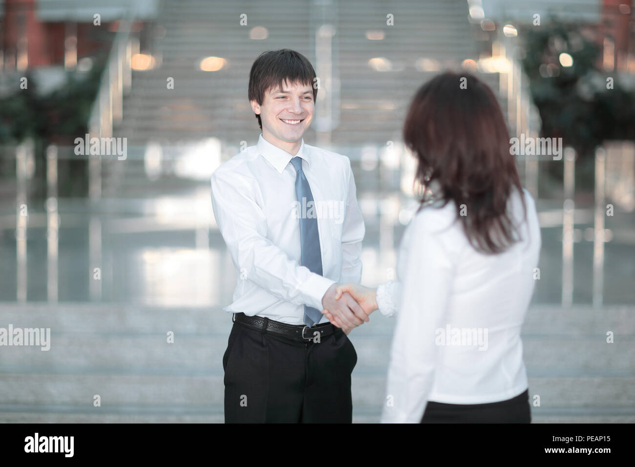 welcoming handshake of a Manager and the customer in the office Stock ...