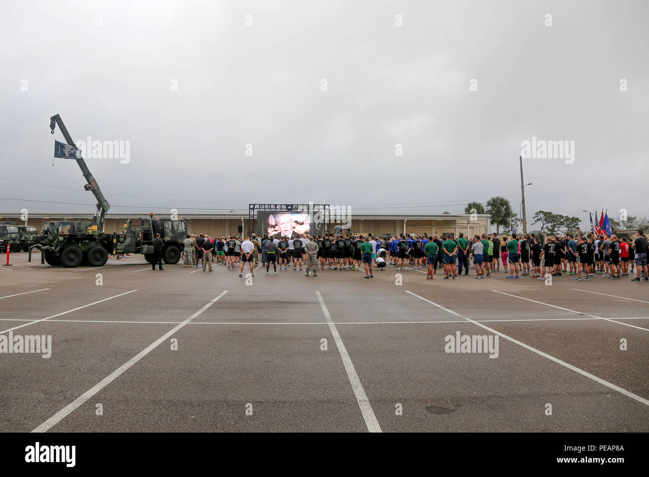 Participants and volunteers watch a memorial video during the opening ...
