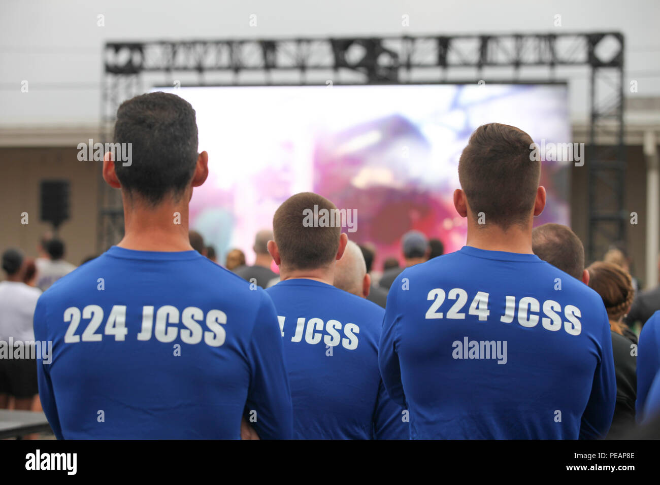 Participants and volunteers watch a memorial video during the opening ...