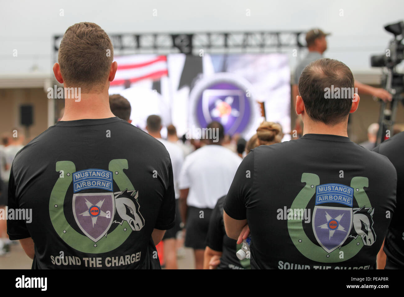 Participants and volunteers watch a memorial video during the opening ...