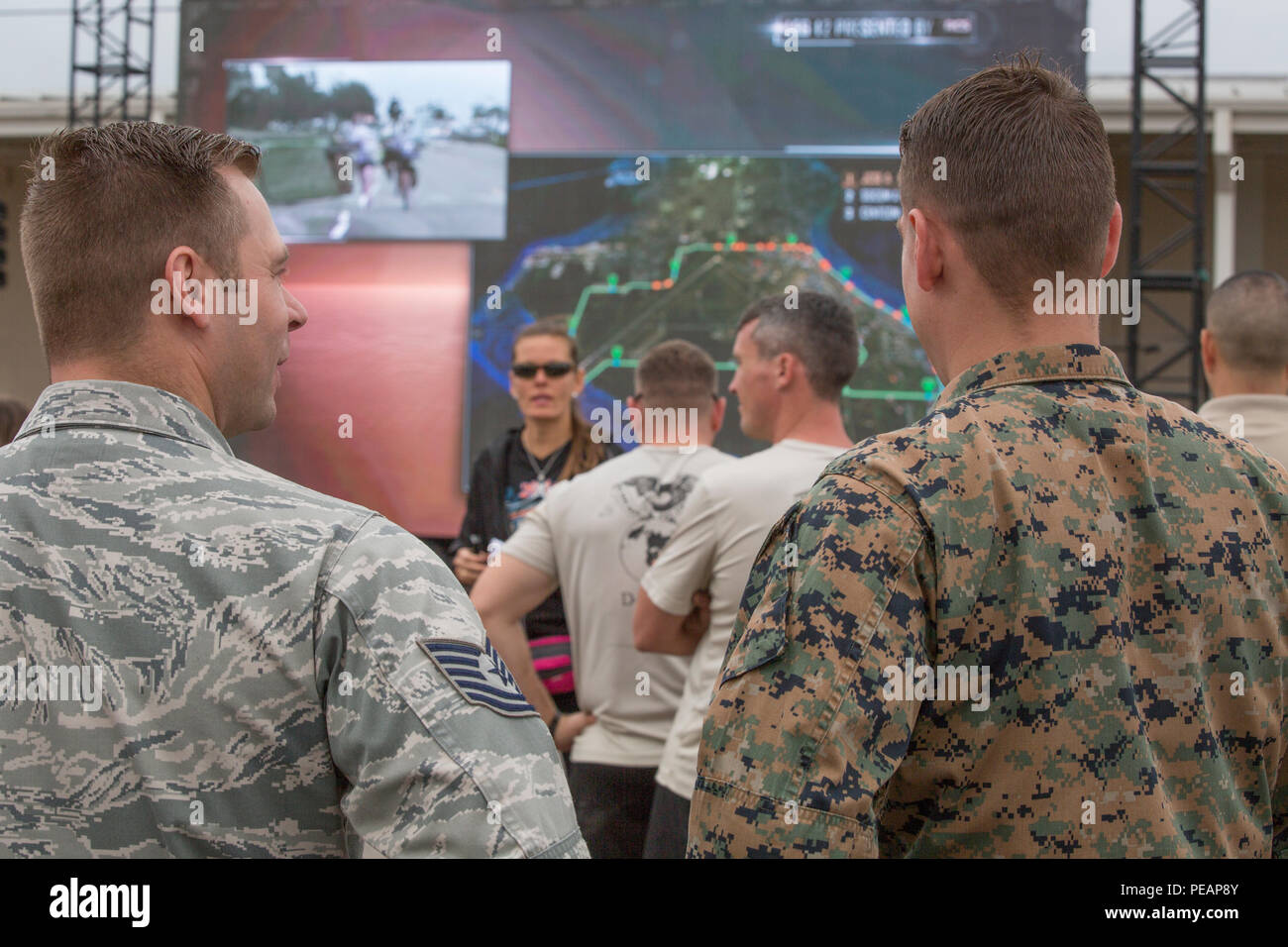 Participants and volunteers watch live streaming of the 35th Annual ...