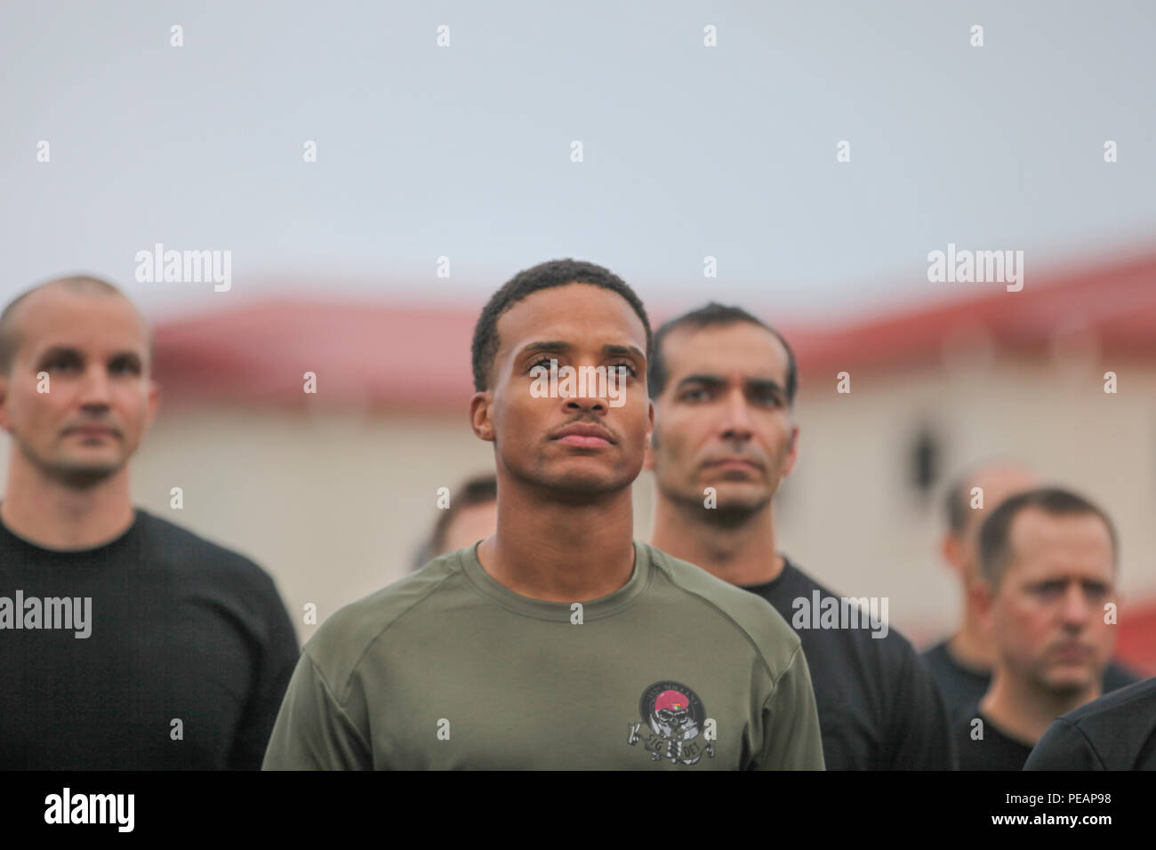 Participants and volunteers watch a memorial video during the opening ...