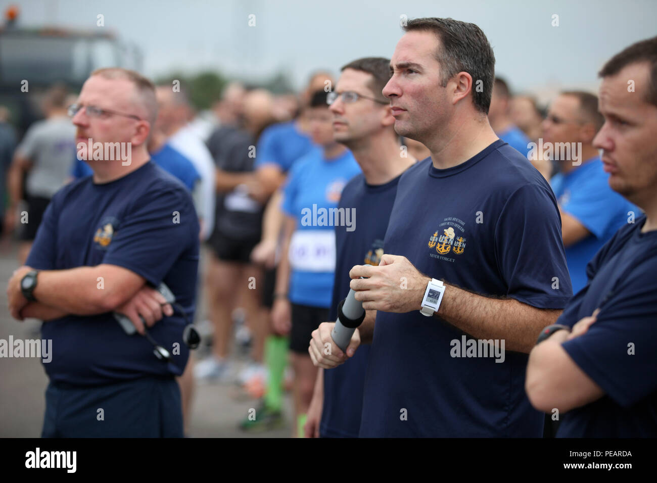 Participants and volunteers listen to opening remarks before the 35th ...