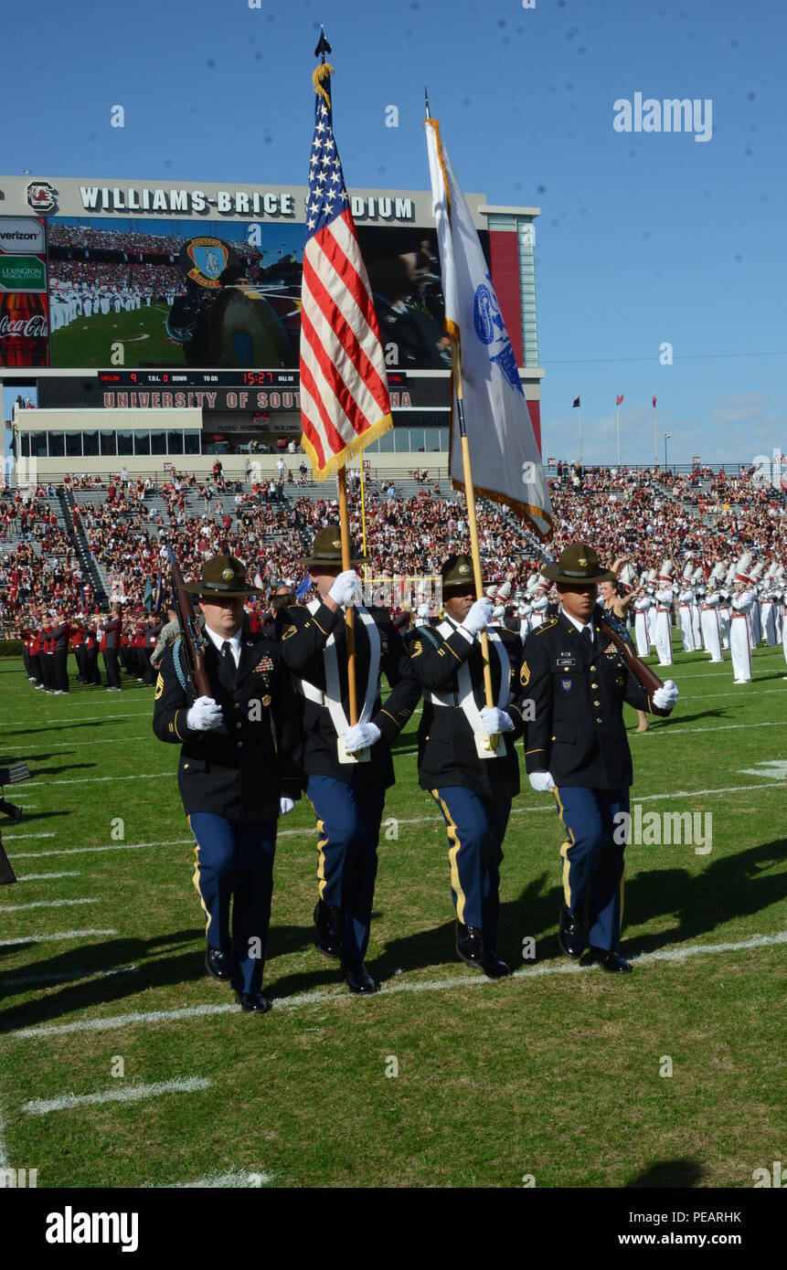 A color guard from Task Force Marshall marches down the sidelines of ...