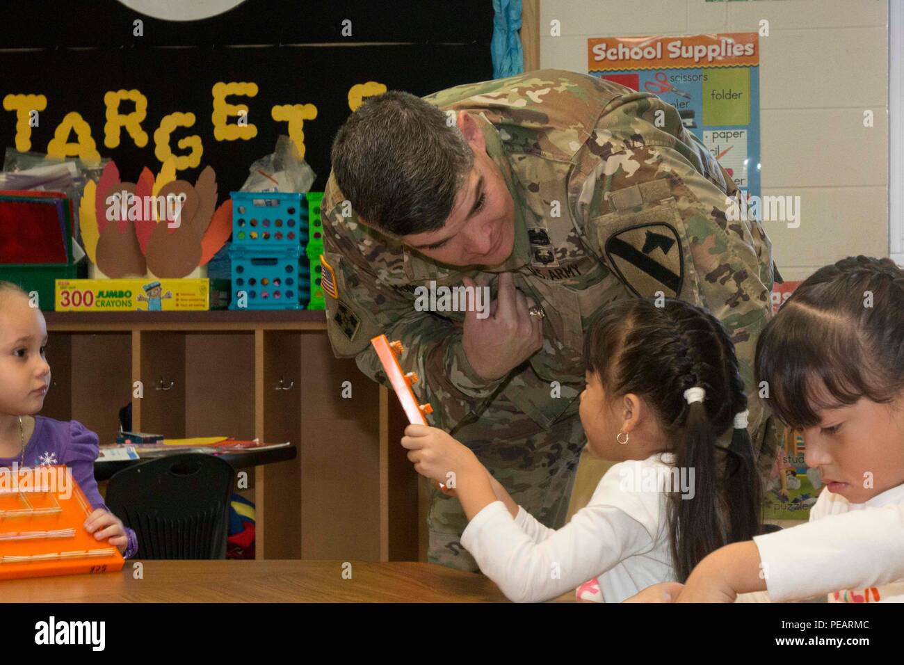 Joceyne Estrella, 4, shows Lt. Col. Ryan McCormack, commander of 2nd ...