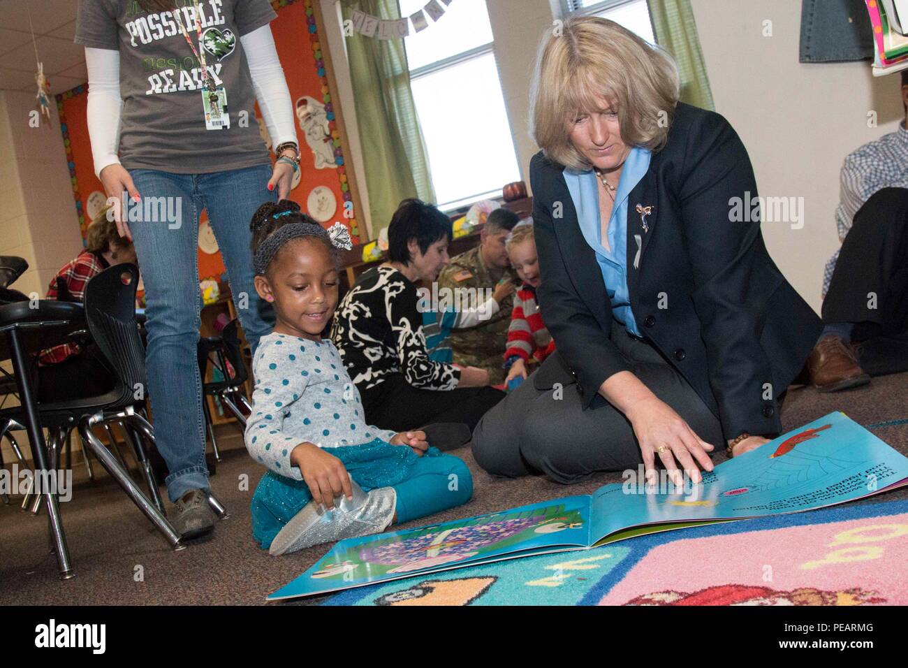 Holleanne Milley, wife of Army chief of staff Gen. Mark Milley, reads a book with Shiloh Girty ...