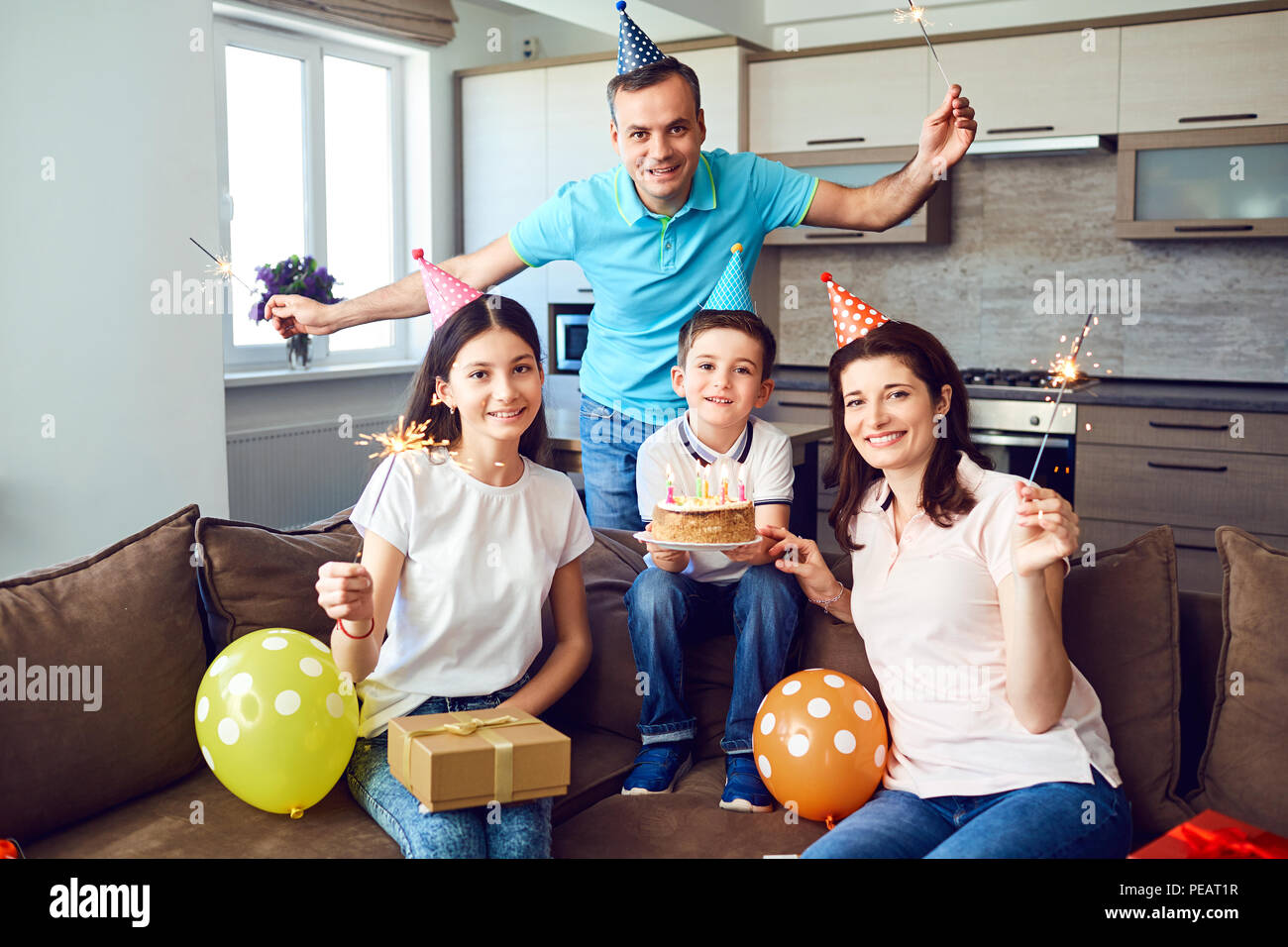Happy family with cake on birthday party Stock Photo - Alamy