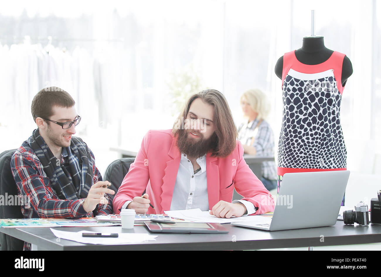 two fashion designers discussing designs of the new models Stock Photo ...