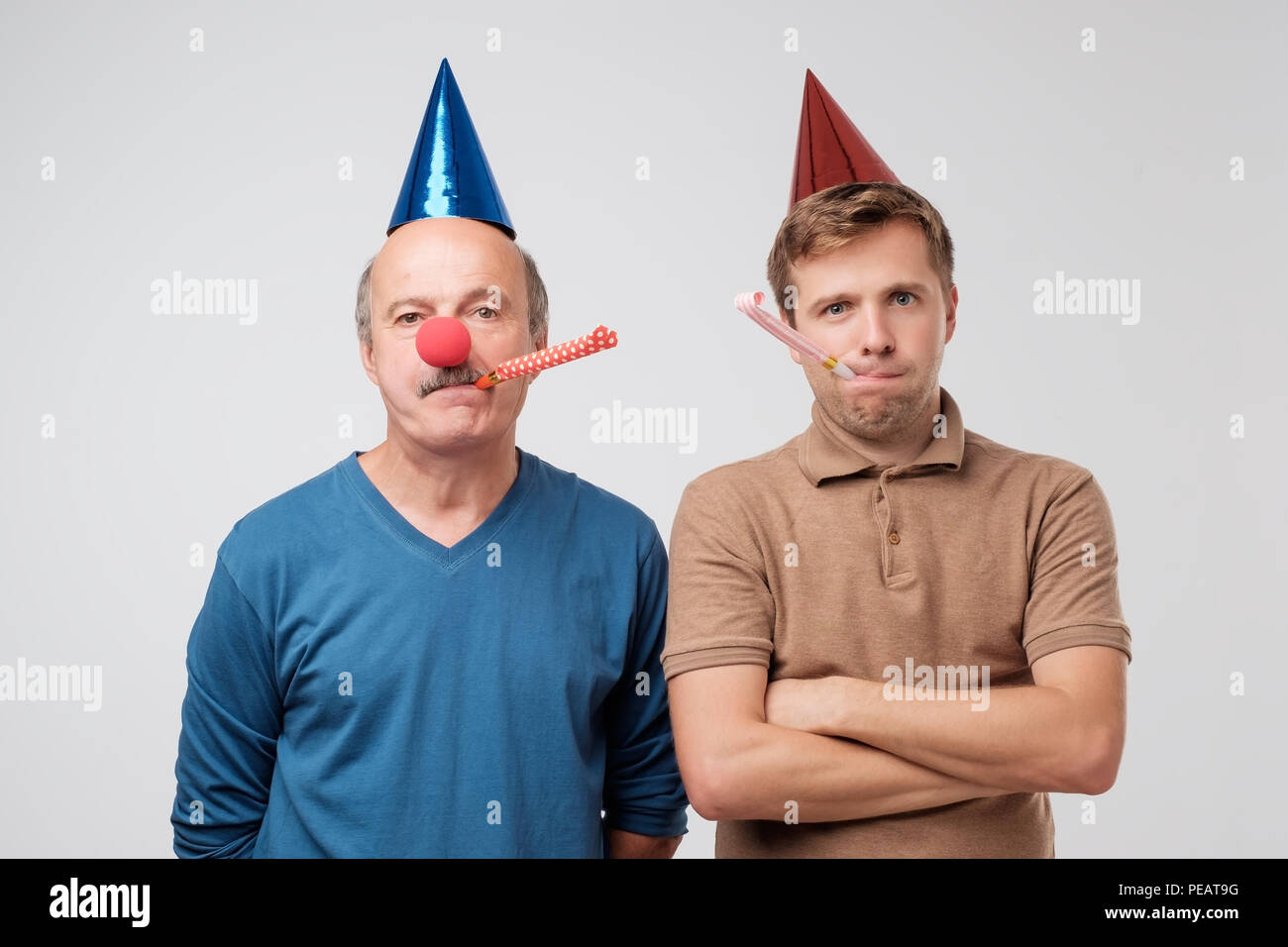 Unhappy guys are on birthday party. Son and father are upset and do not ...