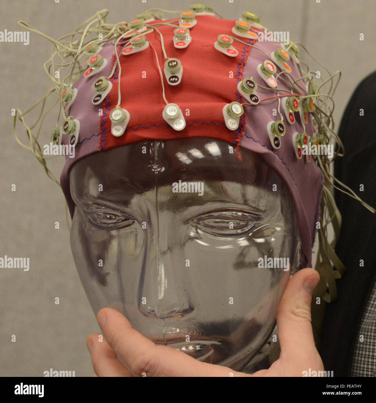 A traditional electroencephalogram, or EEG, head hookup is messy with ...