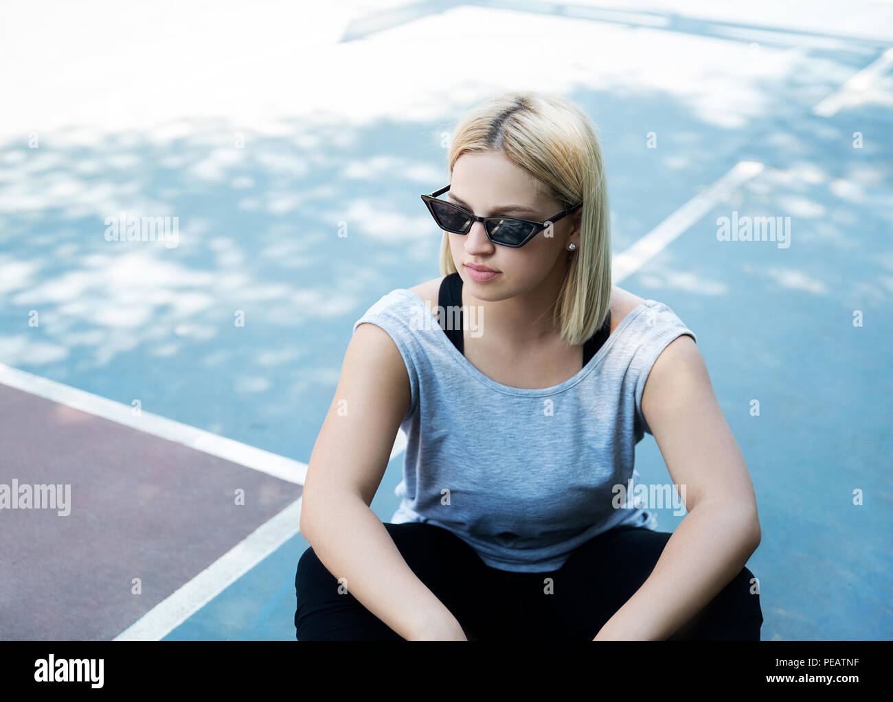 Young woman sitting outdoor hi-res stock photography and images - Alamy