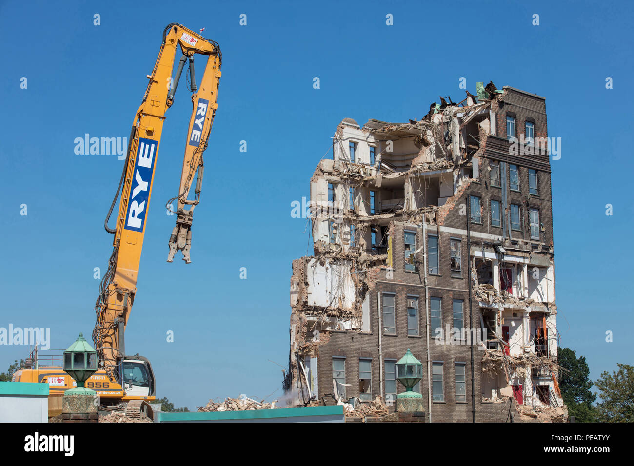 High reach demolition equipment demolishes building to the ground Stock ...