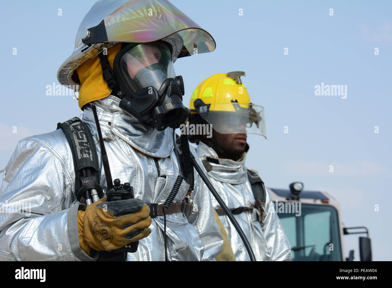 A 379th Civil Engineer Squadron firefighter listens to his radio during ...