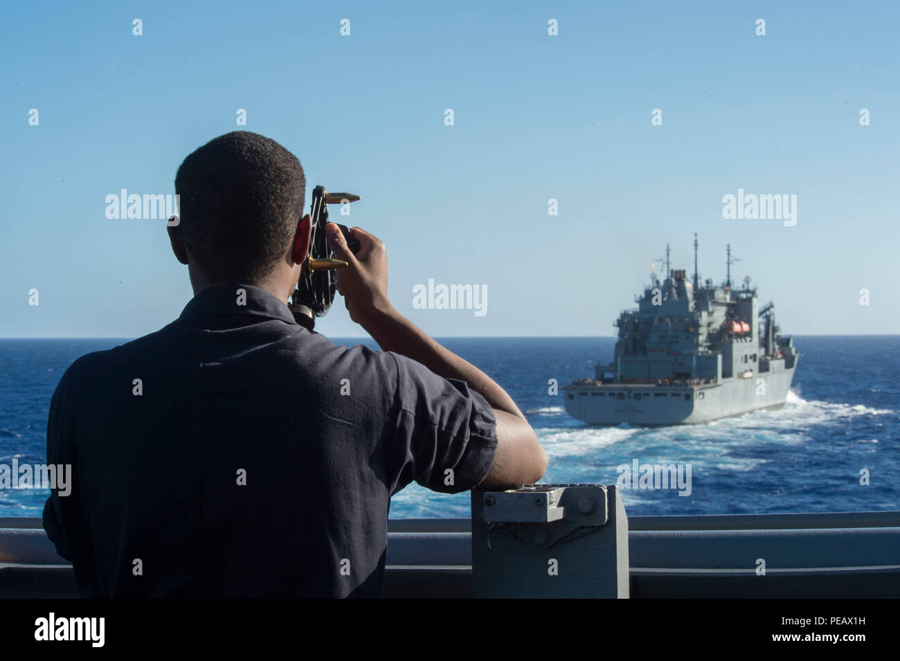 PACIFIC OCEAN (Nov. 26, 2015) Quartermaster 3rd Class Craig Warner uses ...
