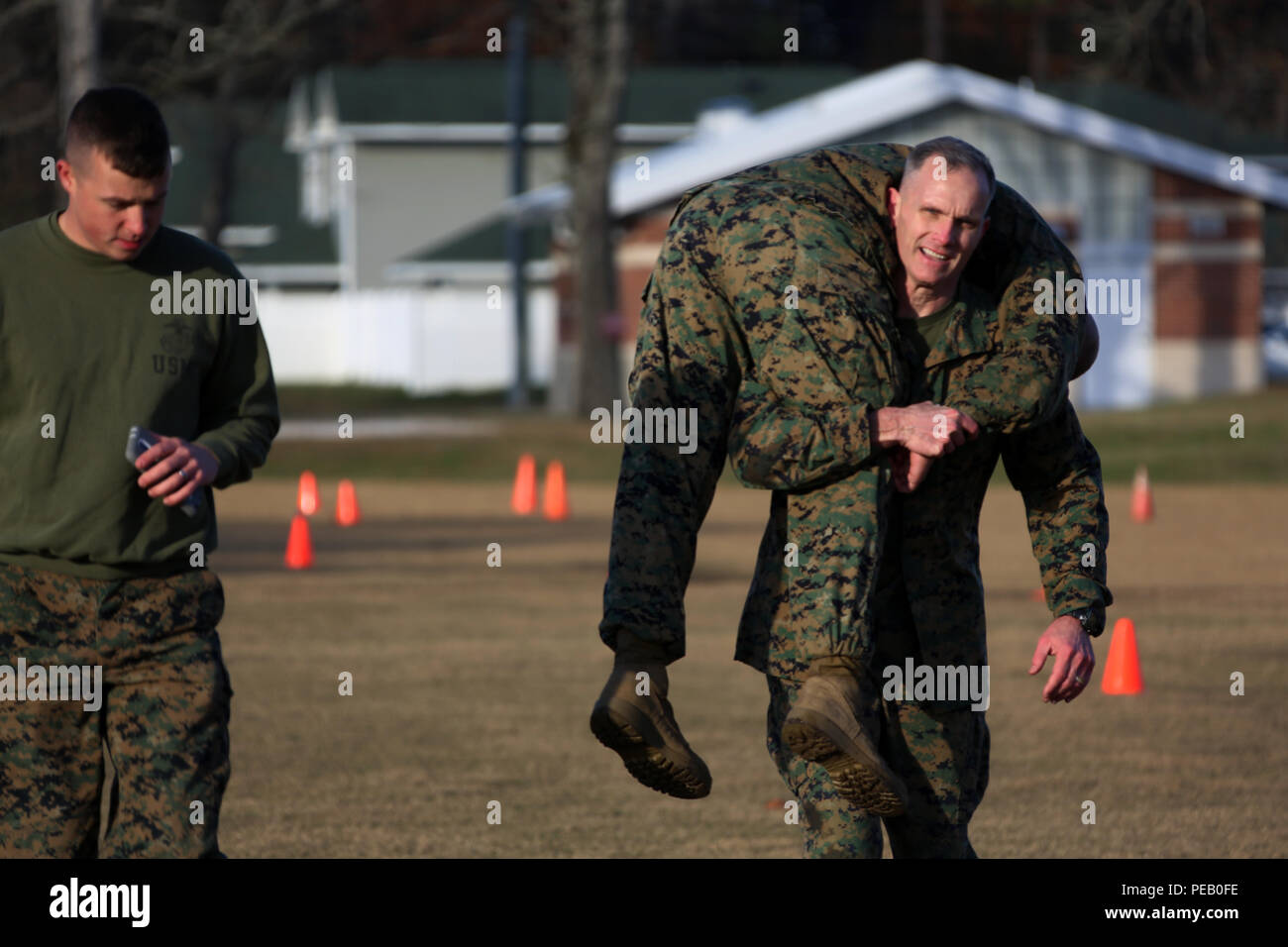 Maj. Gen. Gary Thomas fireman carries his partner through a field ...