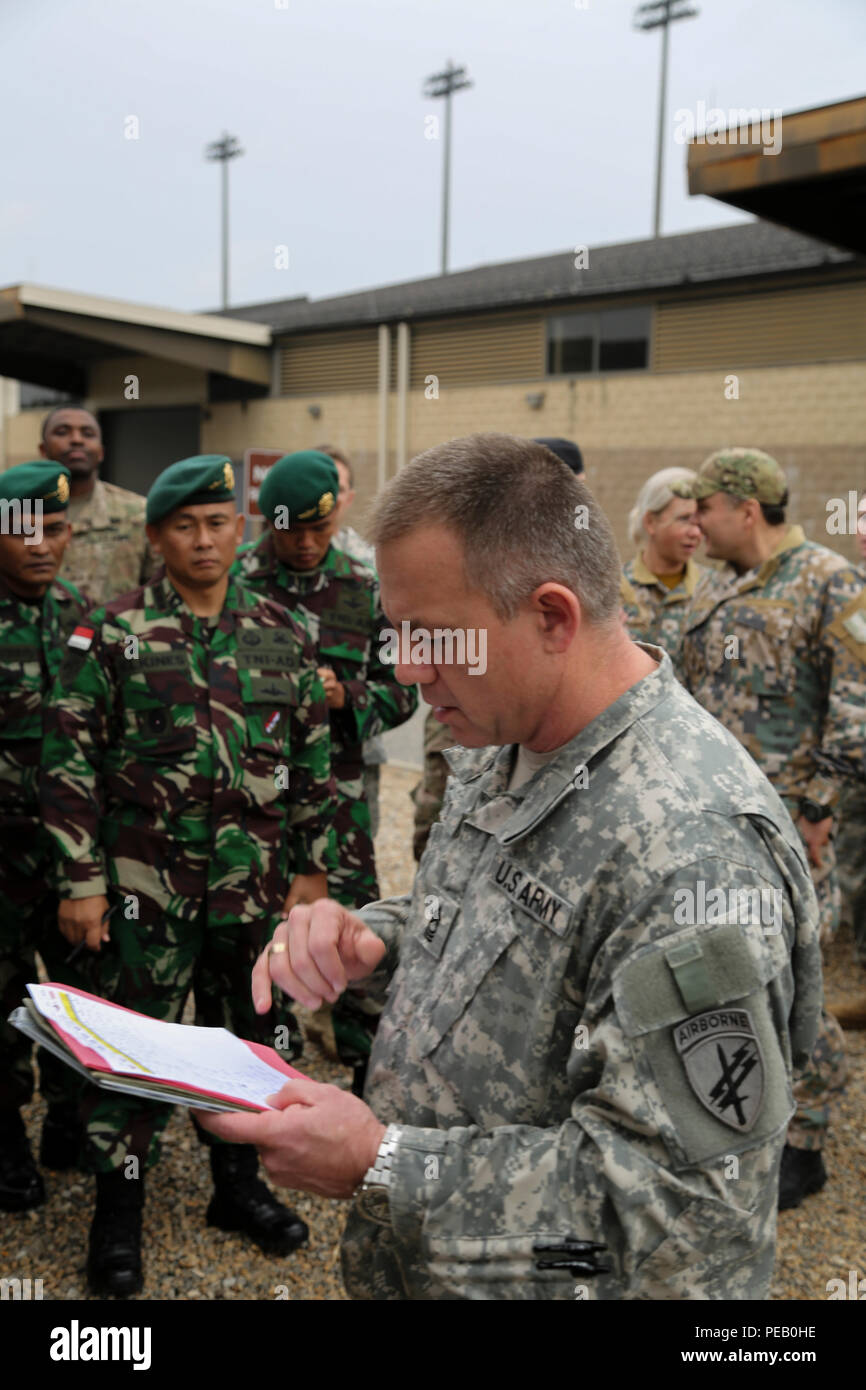 A U.S. jumpmaster reads the manifest during aircraft familiarization in ...