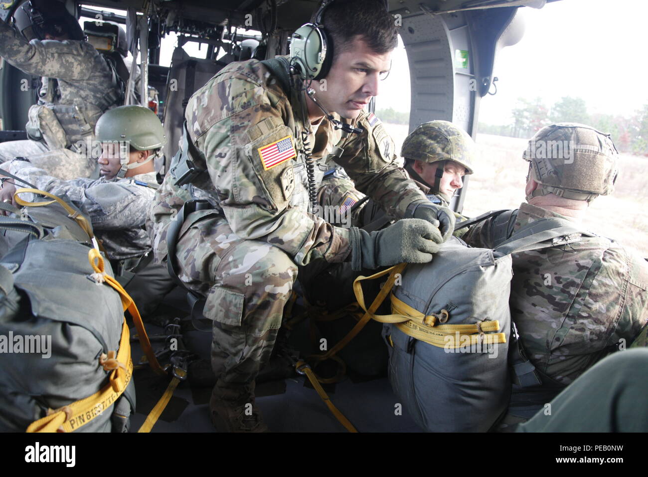 Military members conduct an airborne operation for Operation Toy Drop ...