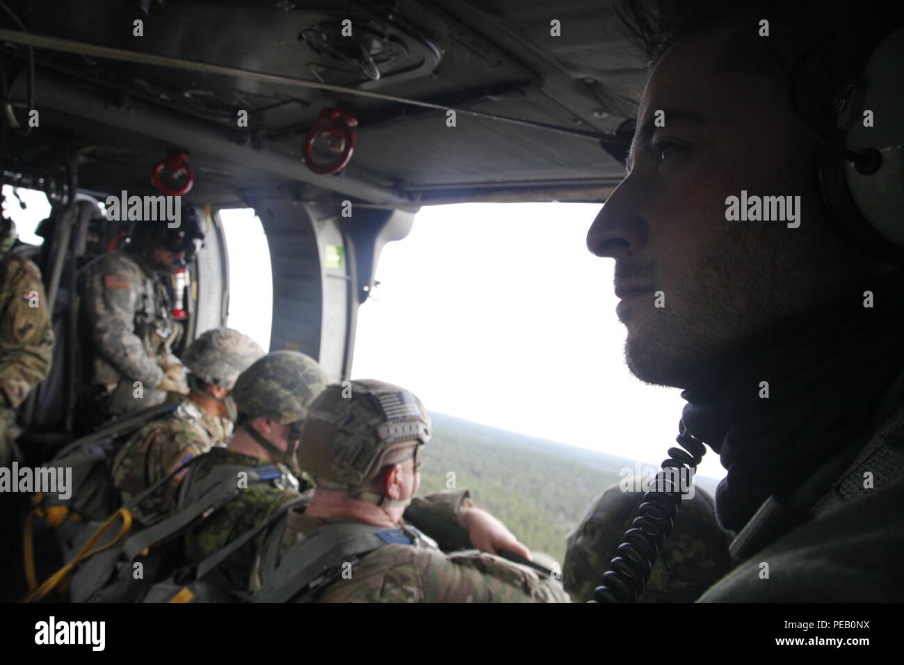 Military members conduct an airborne operation for Operation Toy Drop ...