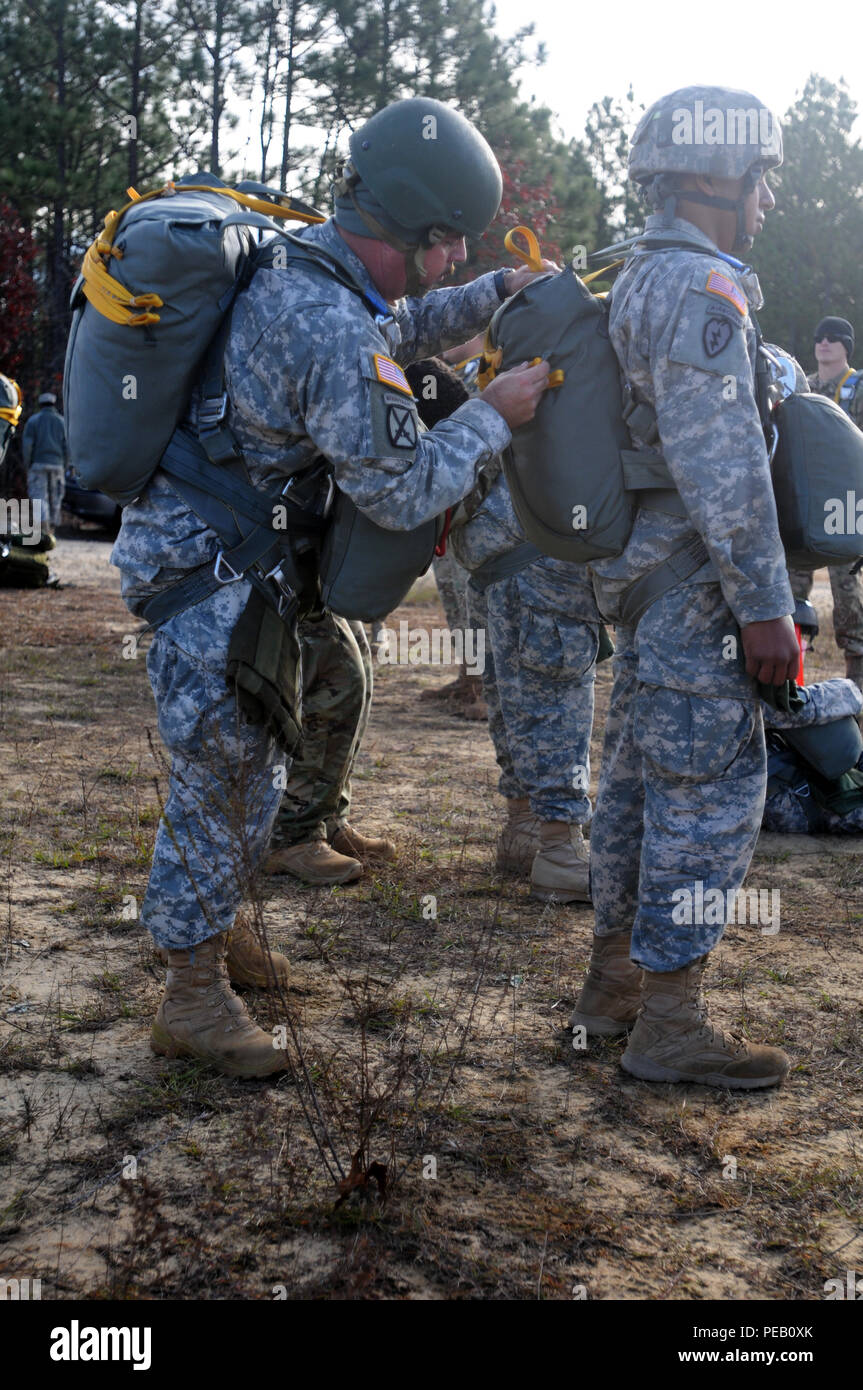 Paratroopers inspect equipment and prepare for boarding a UH-60 Black ...