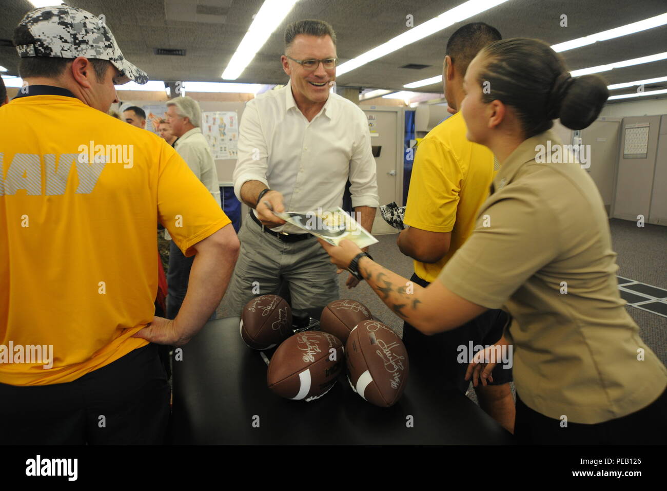151204-N-PA426-068 PEARL HARBOR (Dec. 4, 2015) Howie Long signs a photo ...