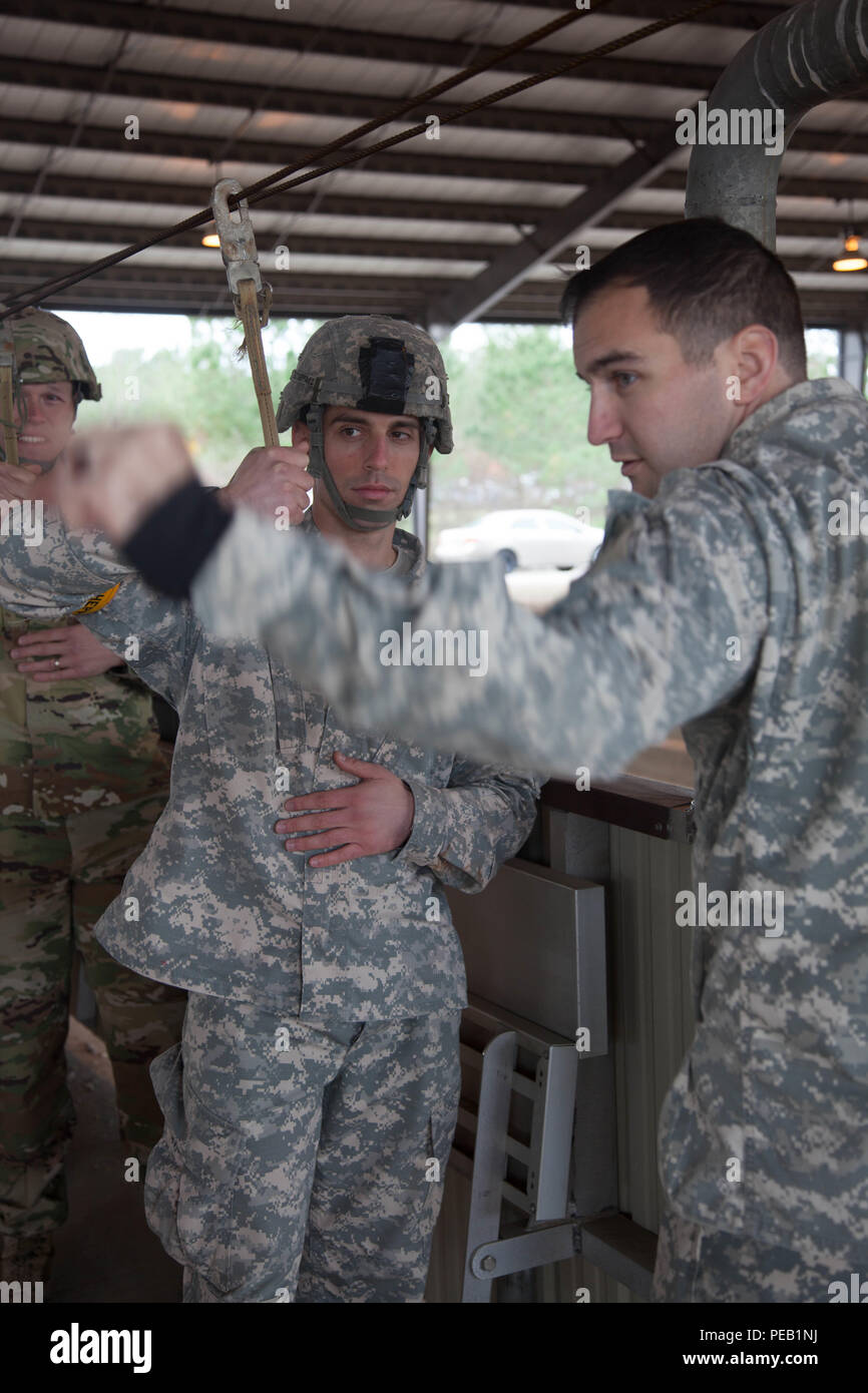 U.S. Army paratroopers watch a jumpmaster give commands during ...
