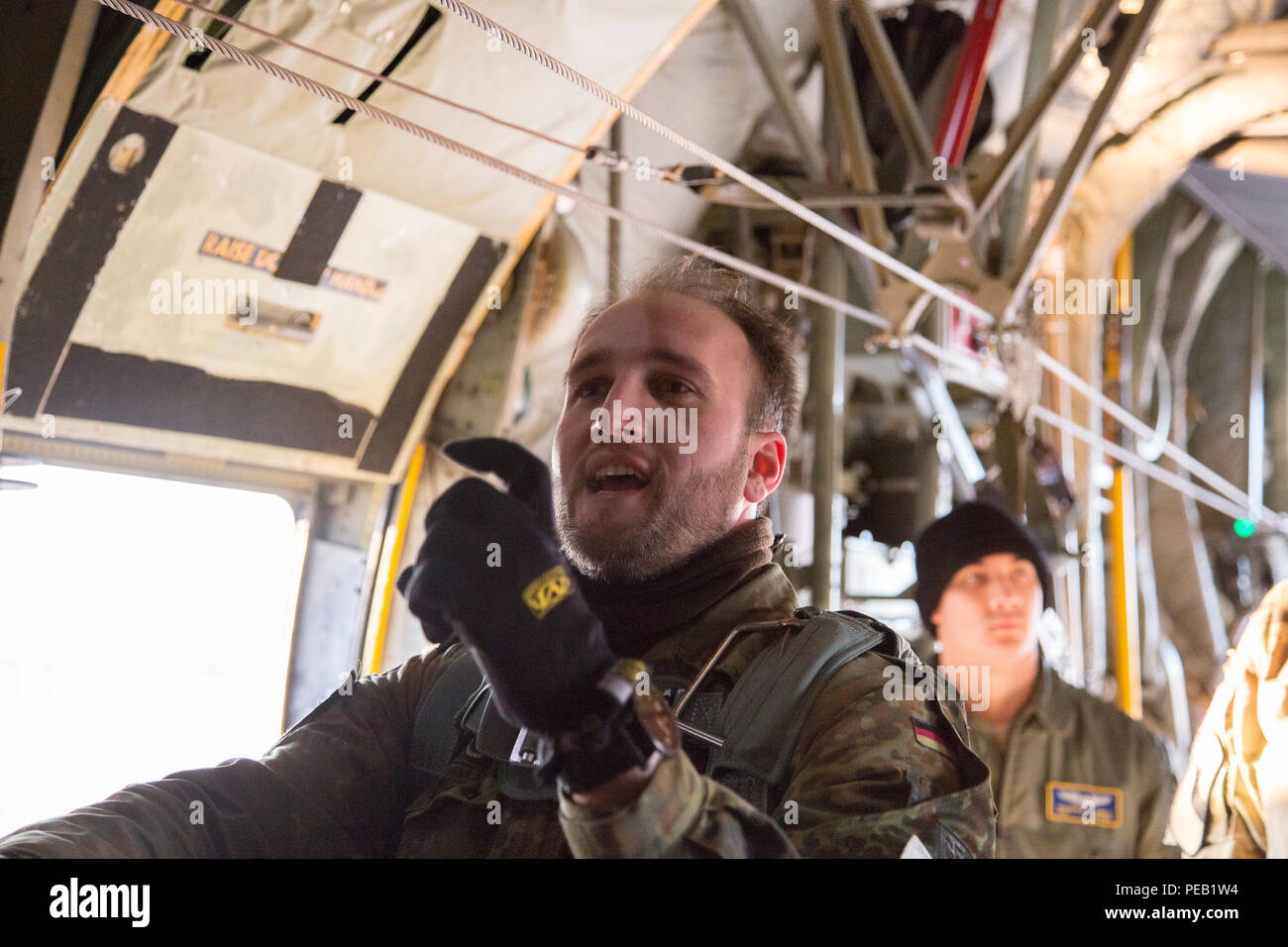 A German jump master performs jump master duties aboard a C-130 ...