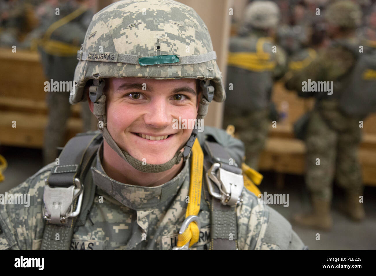 A U.S. Army paratrooper smiles as he waits in his chalk for airborne ...