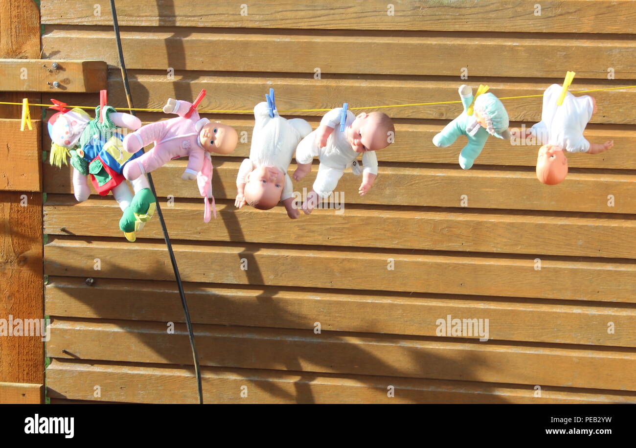 Drybabies - baby dolls dry on a line Stock Photo - Alamy