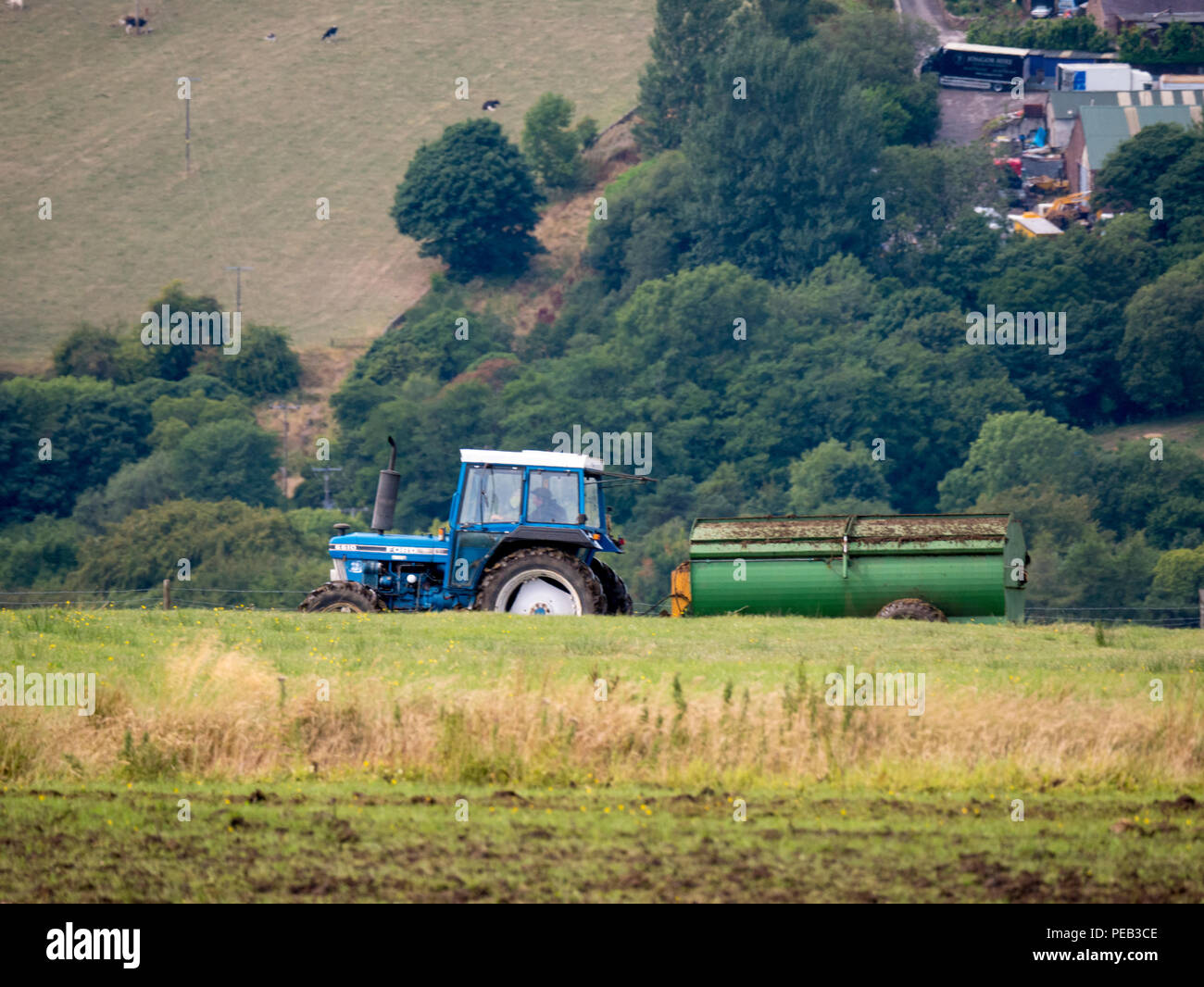 Tractor muck spreading in the Staffordshire Moorlands, UK Stock Photo ...