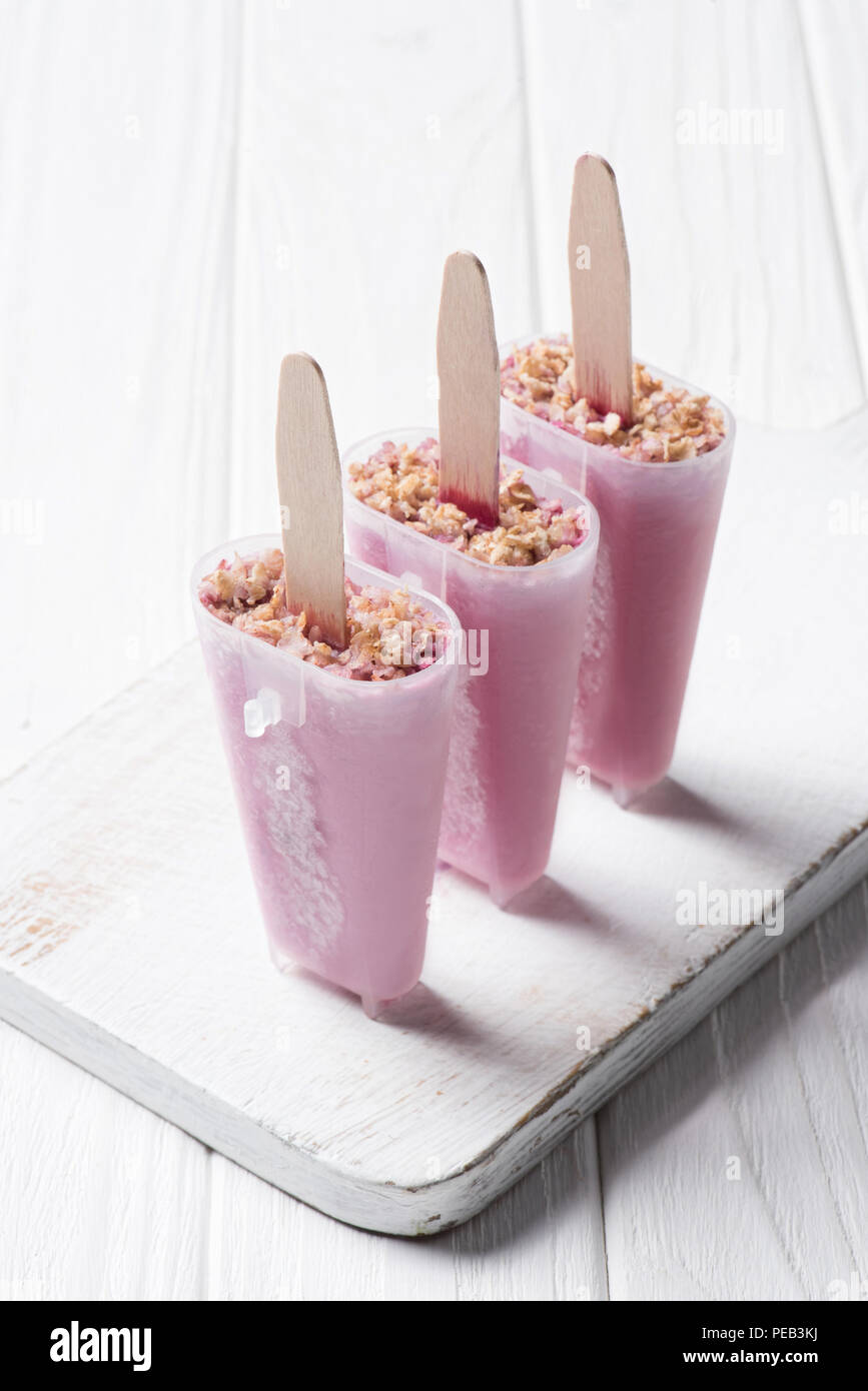 Berry ice pops in molds on wooden background Stock Photo - Alamy