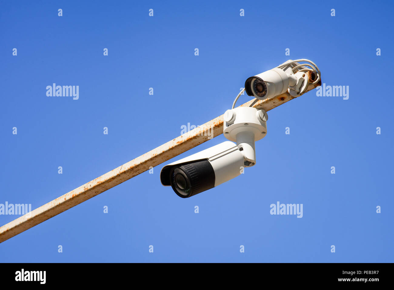 close up view of security cameras on pole against bright blue sky Stock ...