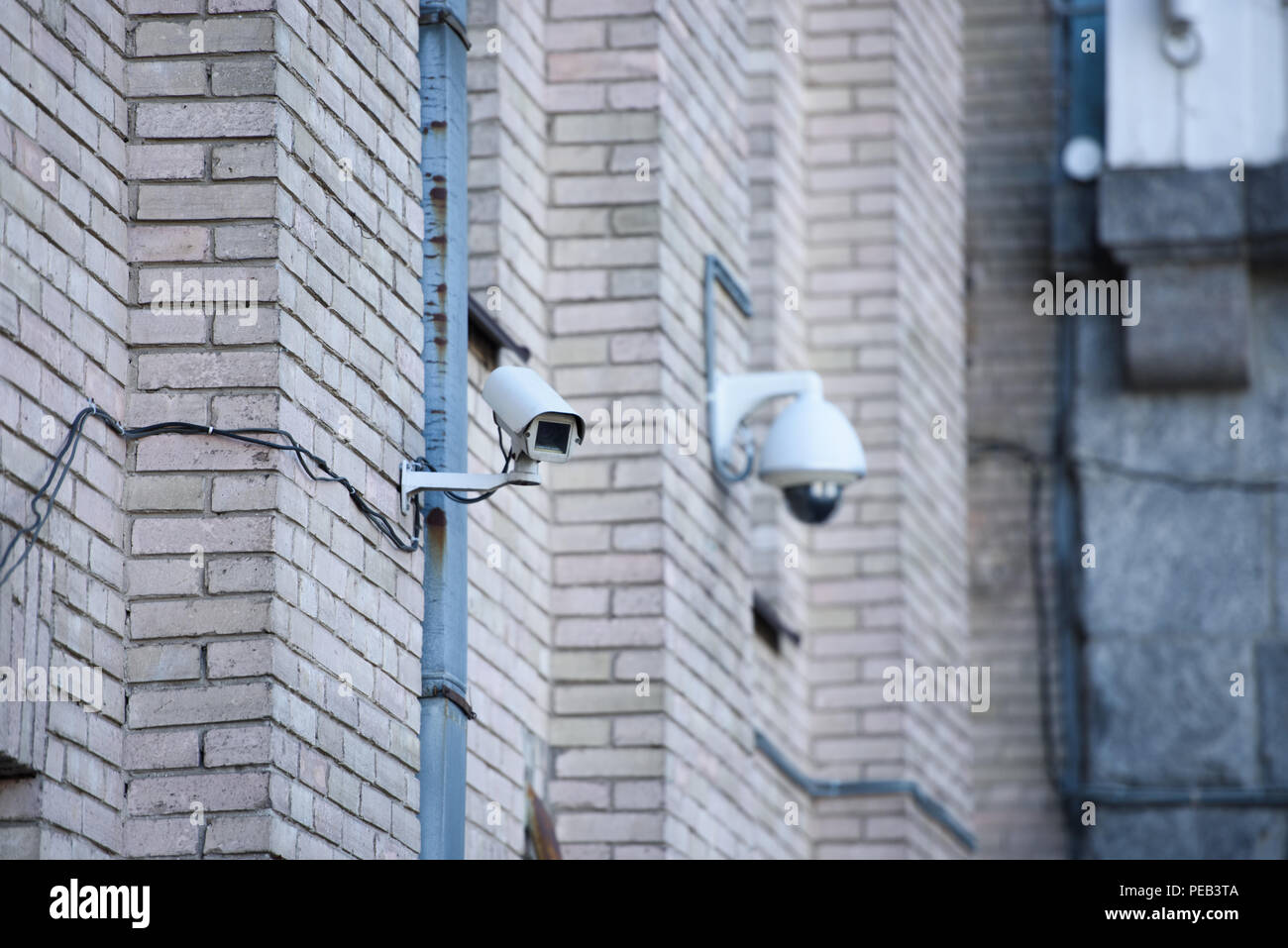 close up view of security cameras on brick building facade Stock Photo ...