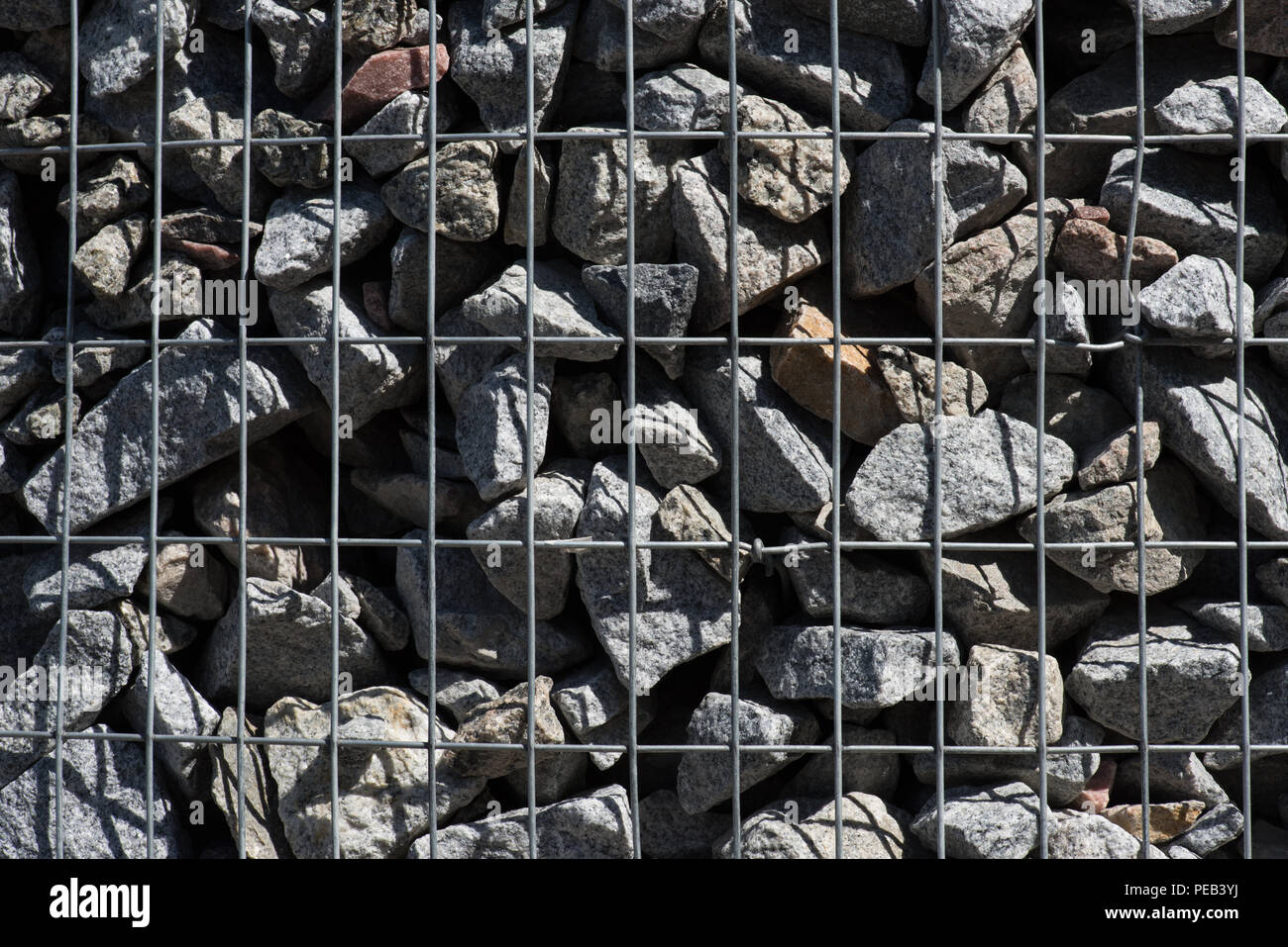 full frame image of metal cage covered stones background Stock Photo ...