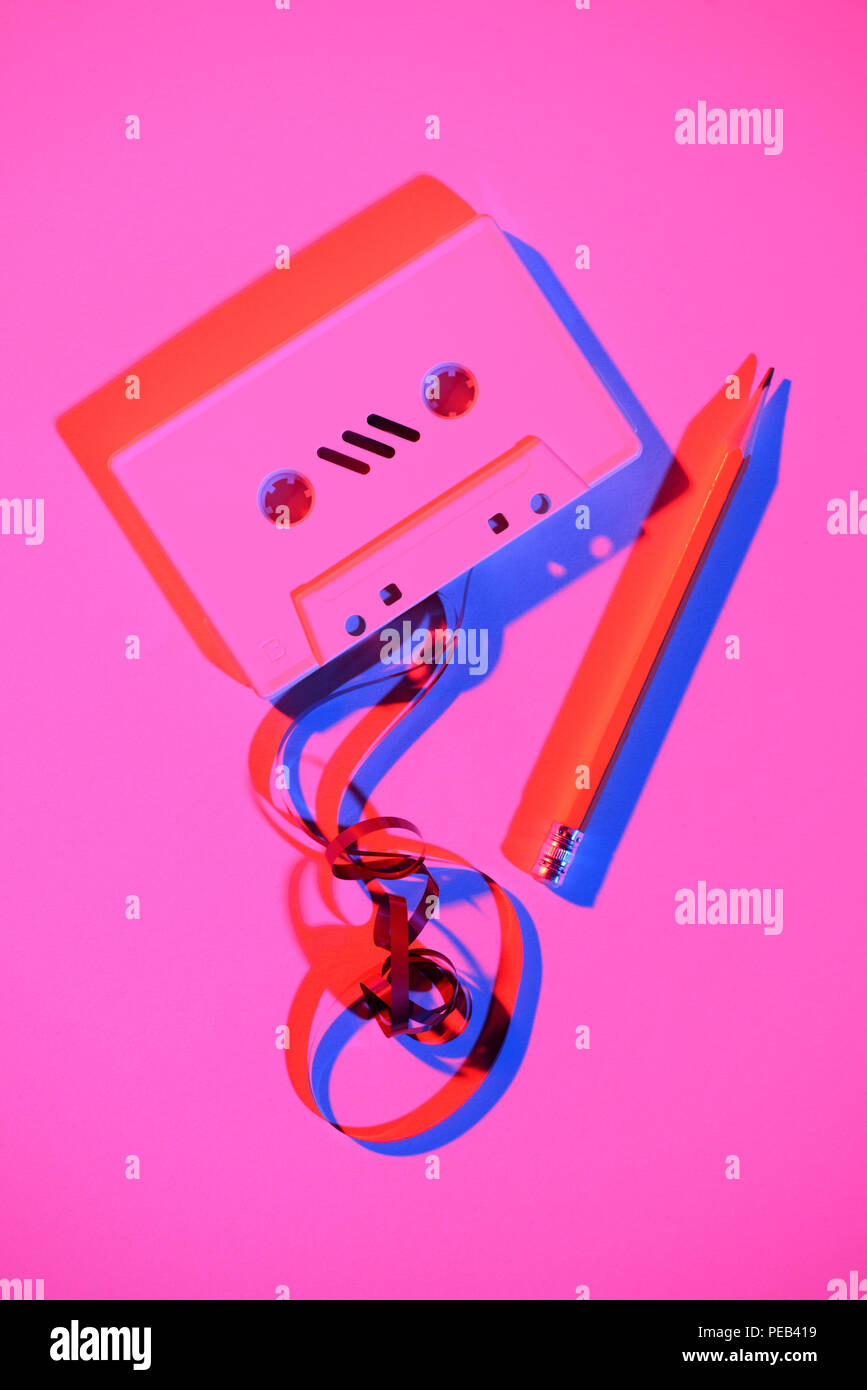 toned pink picture of retro audio cassette with pencil and tape Stock ...