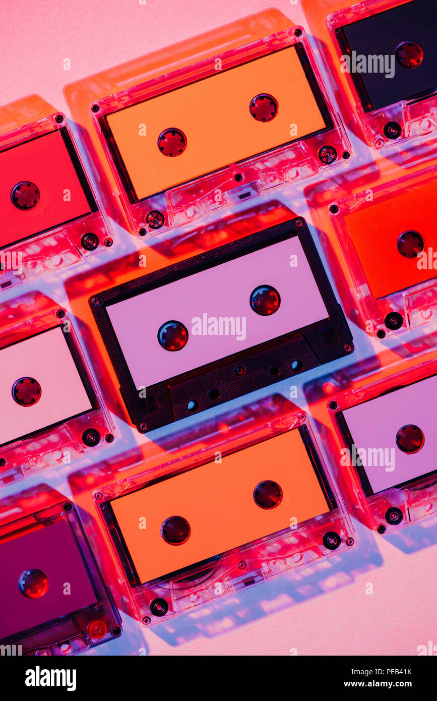 toned picture of colorful retro audio cassettes on pink background ...