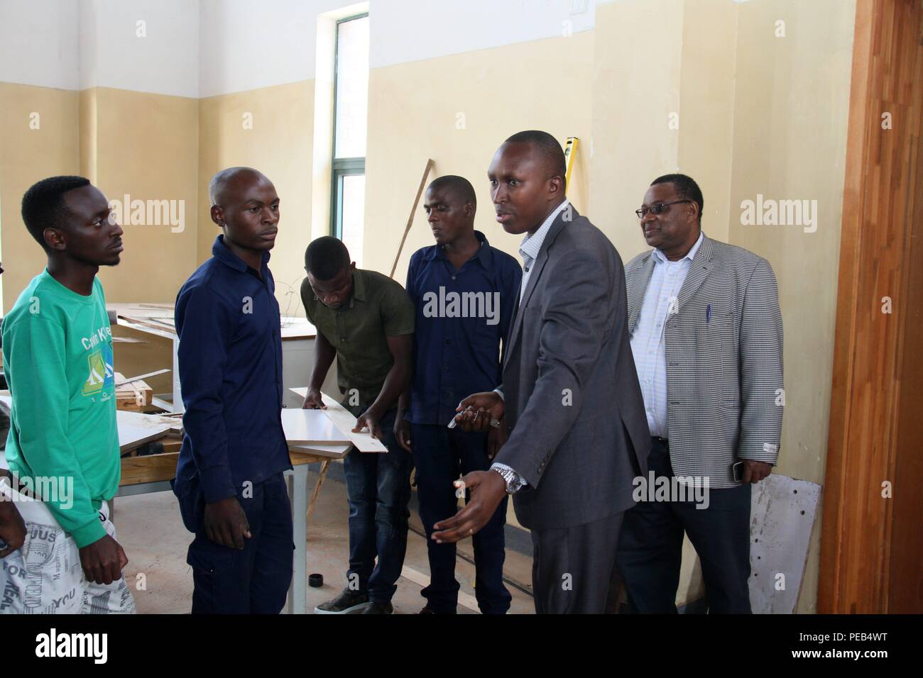 Musanze, Rwanda. 13th Aug, 2018. Emile Abayisenga (2nd R), principal of ...