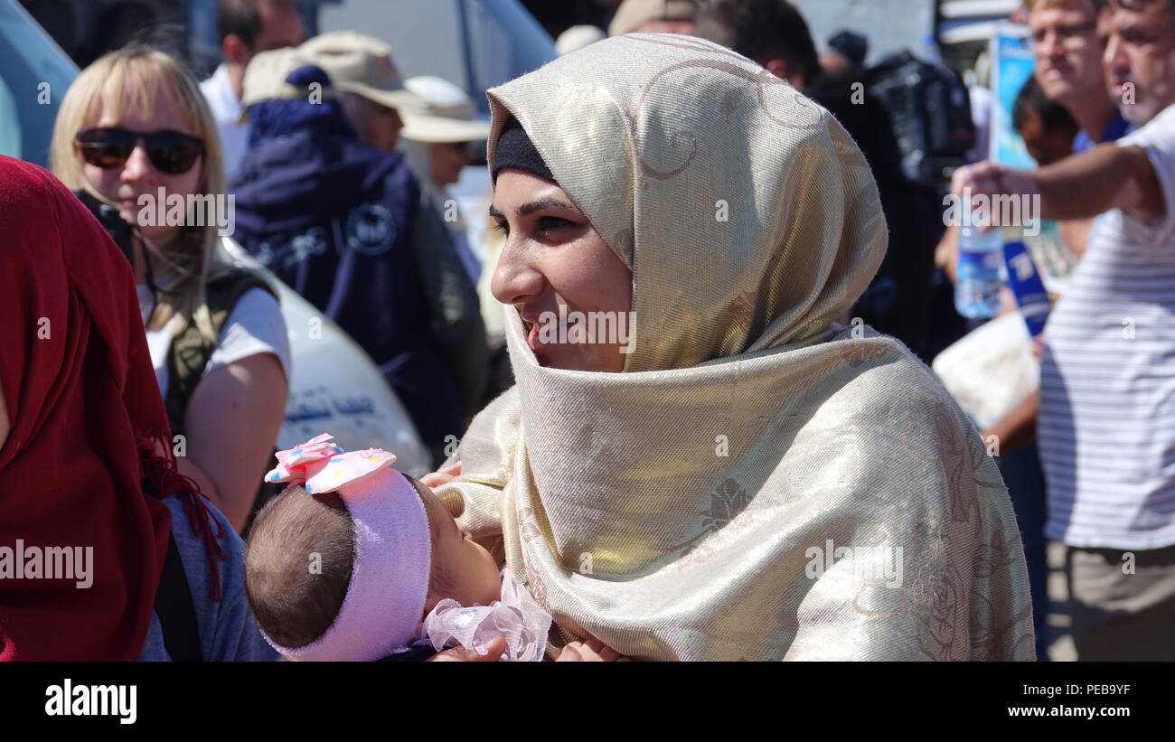 Syrian refugee holds baby in hi-res stock photography and images - Alamy