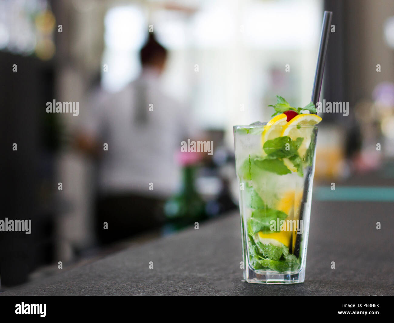 Mojito cocktail in a glass on the long bar counter Stock Photo - Alamy
