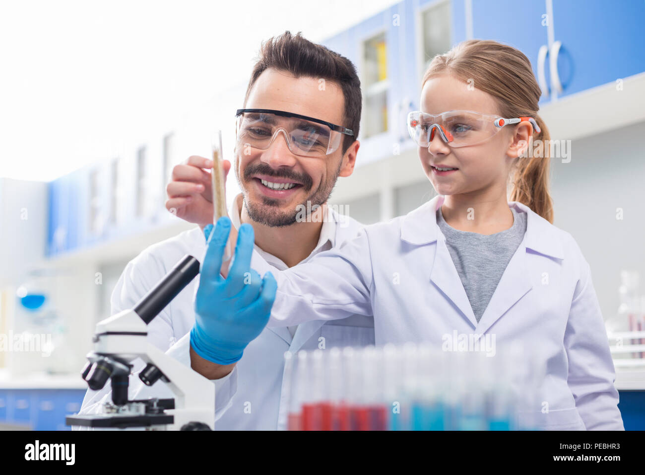 Smart child. Positive joyful nice girl smiling and looking at the test ...